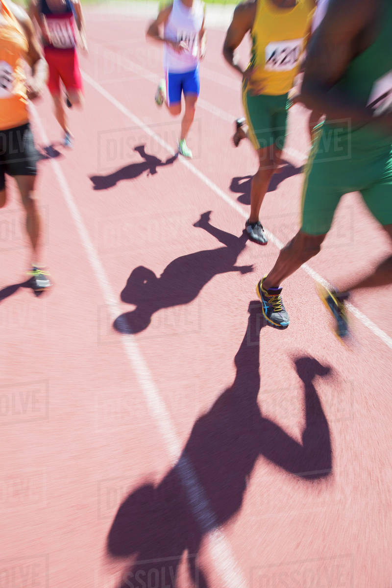 Runners racing on track - Royalty-free Stock Photo | Dissolve