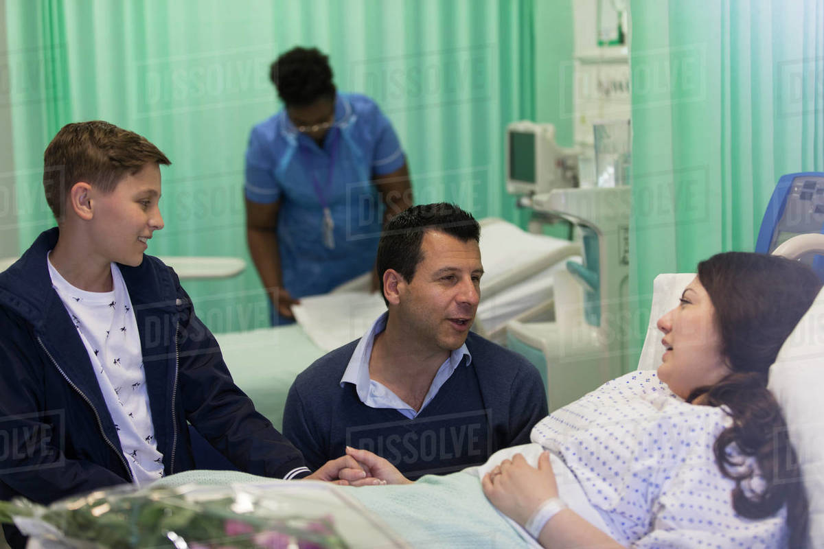 Family visiting, talking with patient in hospital ward - Royalty-free ...