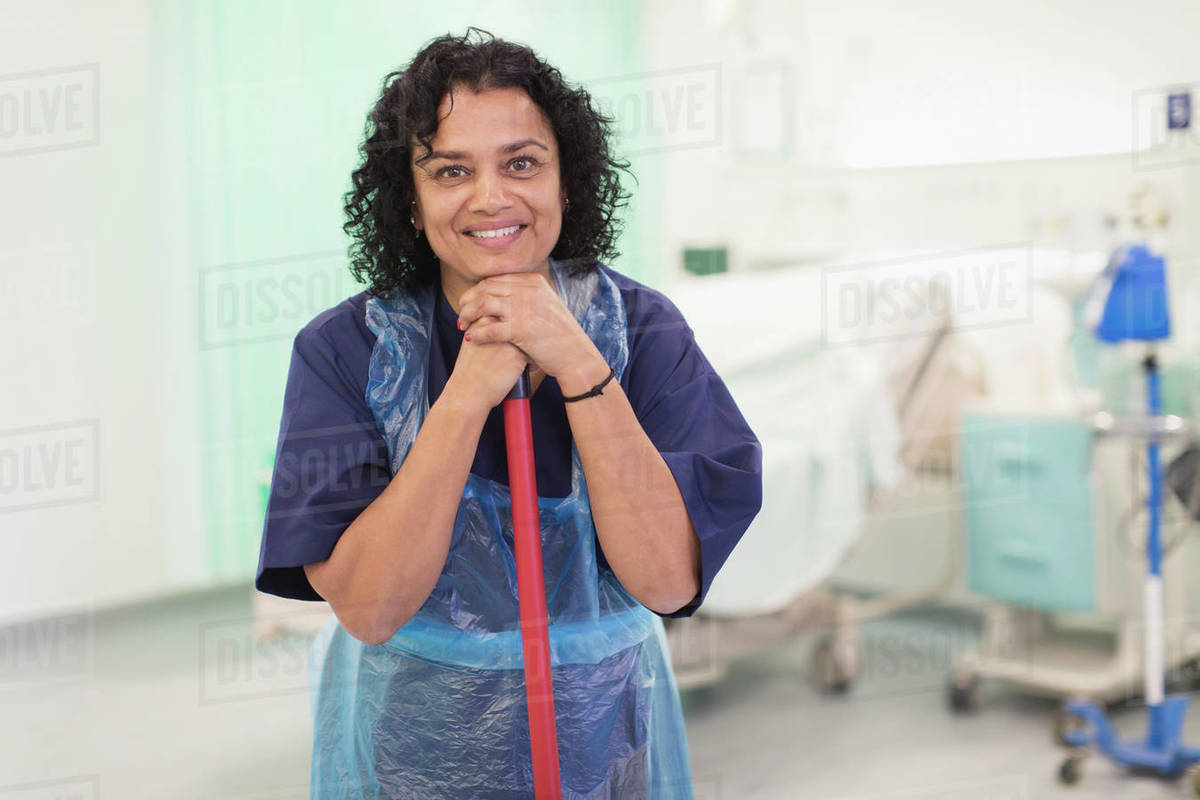 Portrait smiling, confident female orderly cleaning hospital ward ...