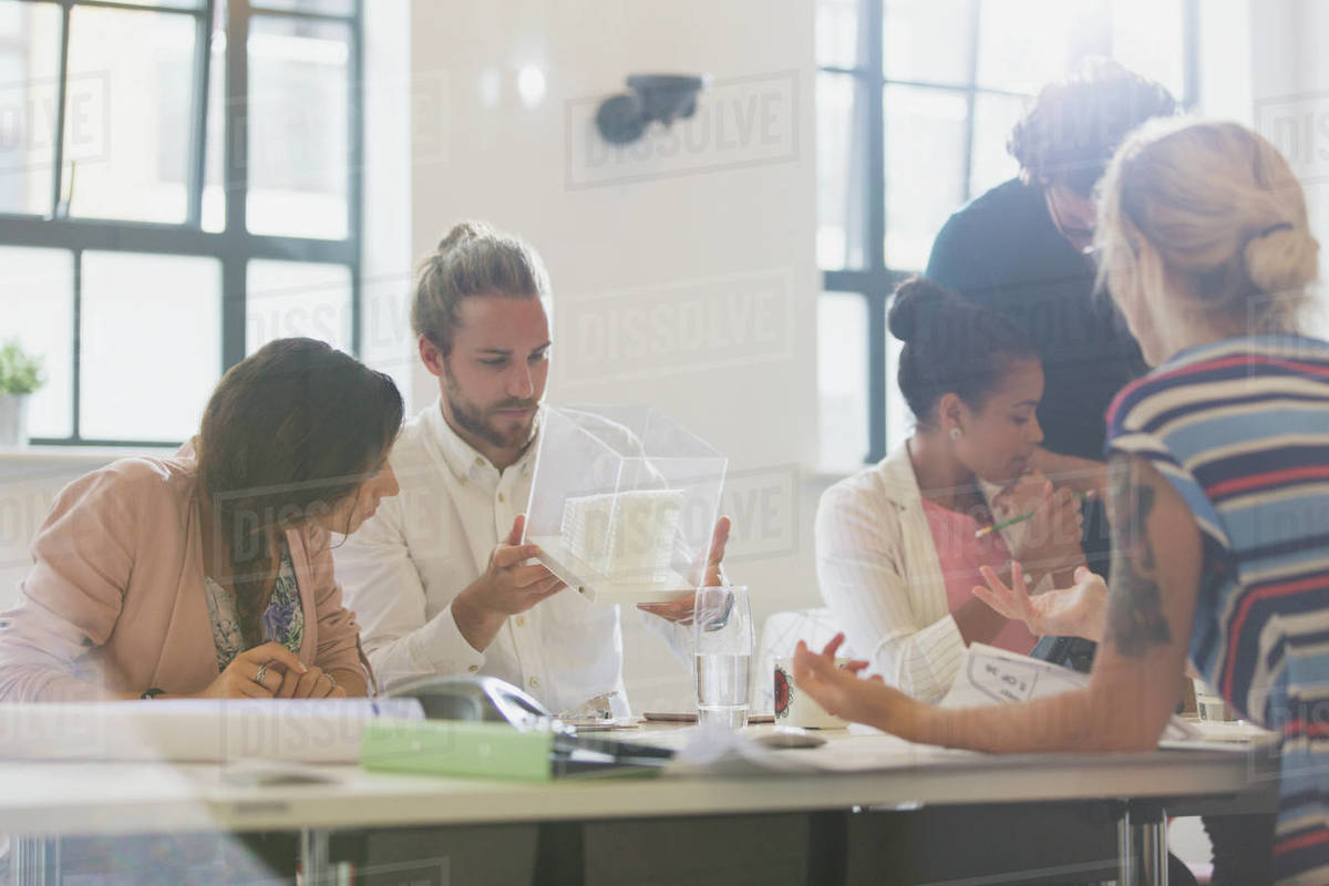 Architects examining model in conference room meeting - Royalty-free ...
