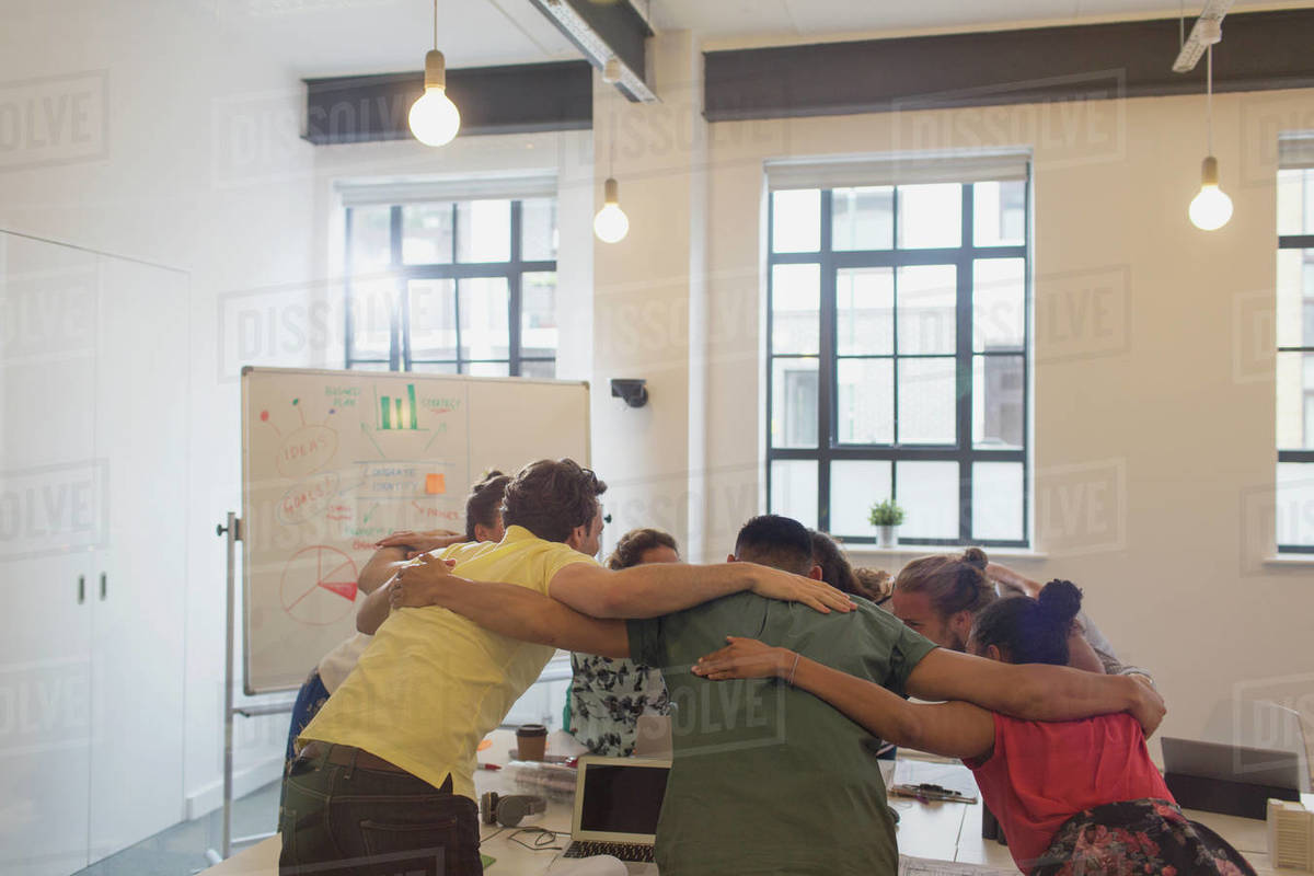 Designers bonding in huddle in conference room meeting - Stock Photo ...