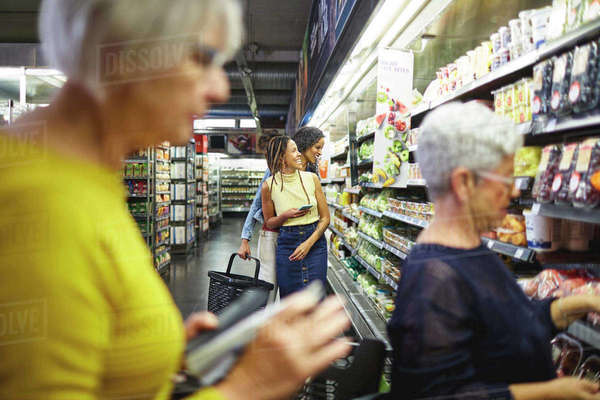 Women grocery shopping in supermarket - Royalty-free Stock Photo | Dissolve