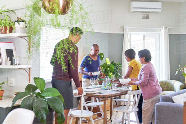 Mature couples setting dining table for lunch - Royalty-free Stock ...
