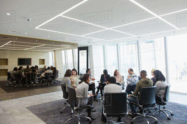 Business people talking in circle in conference room meeting - Royalty ...