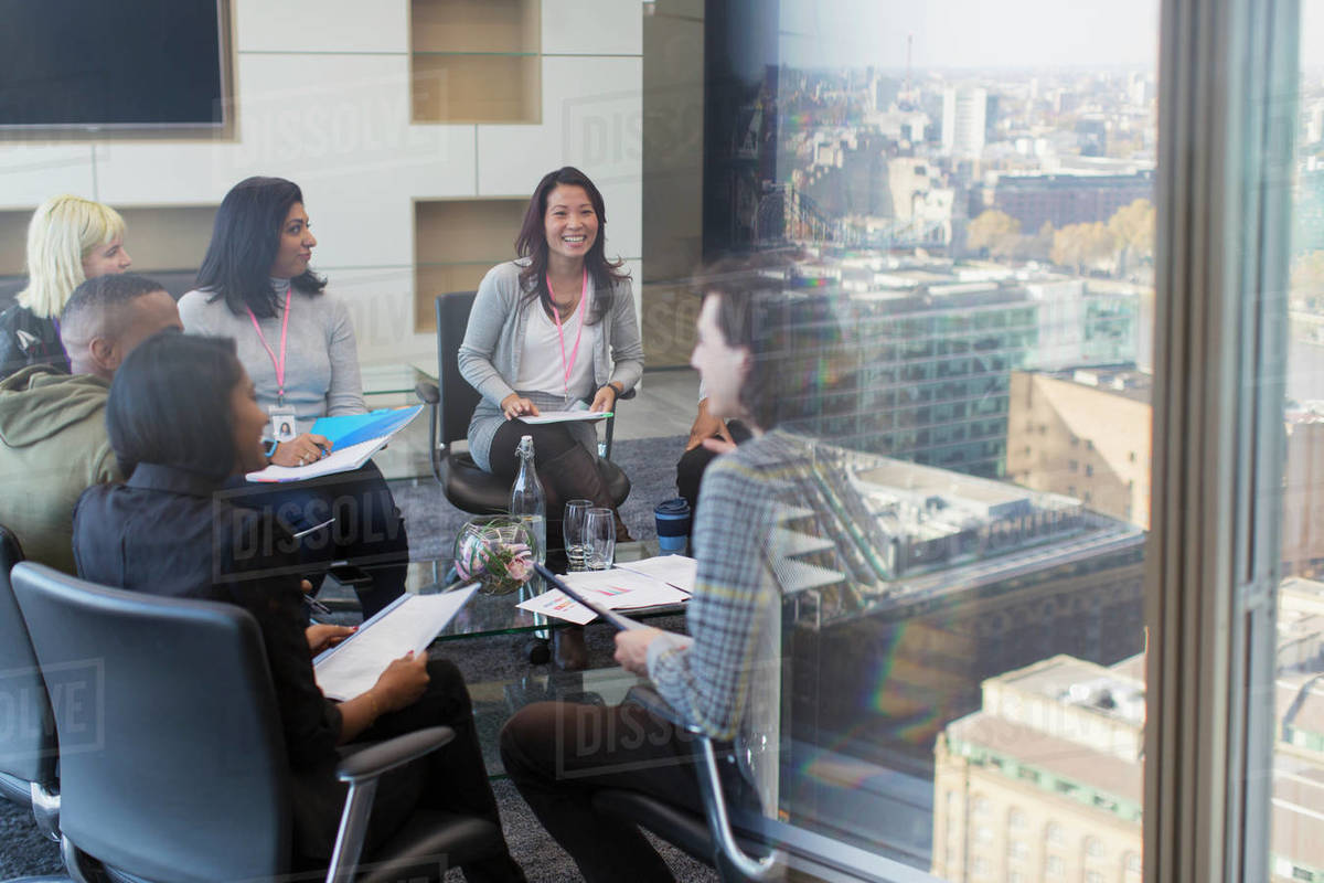 Business people talking in urban conference room meeting - Stock Photo ...
