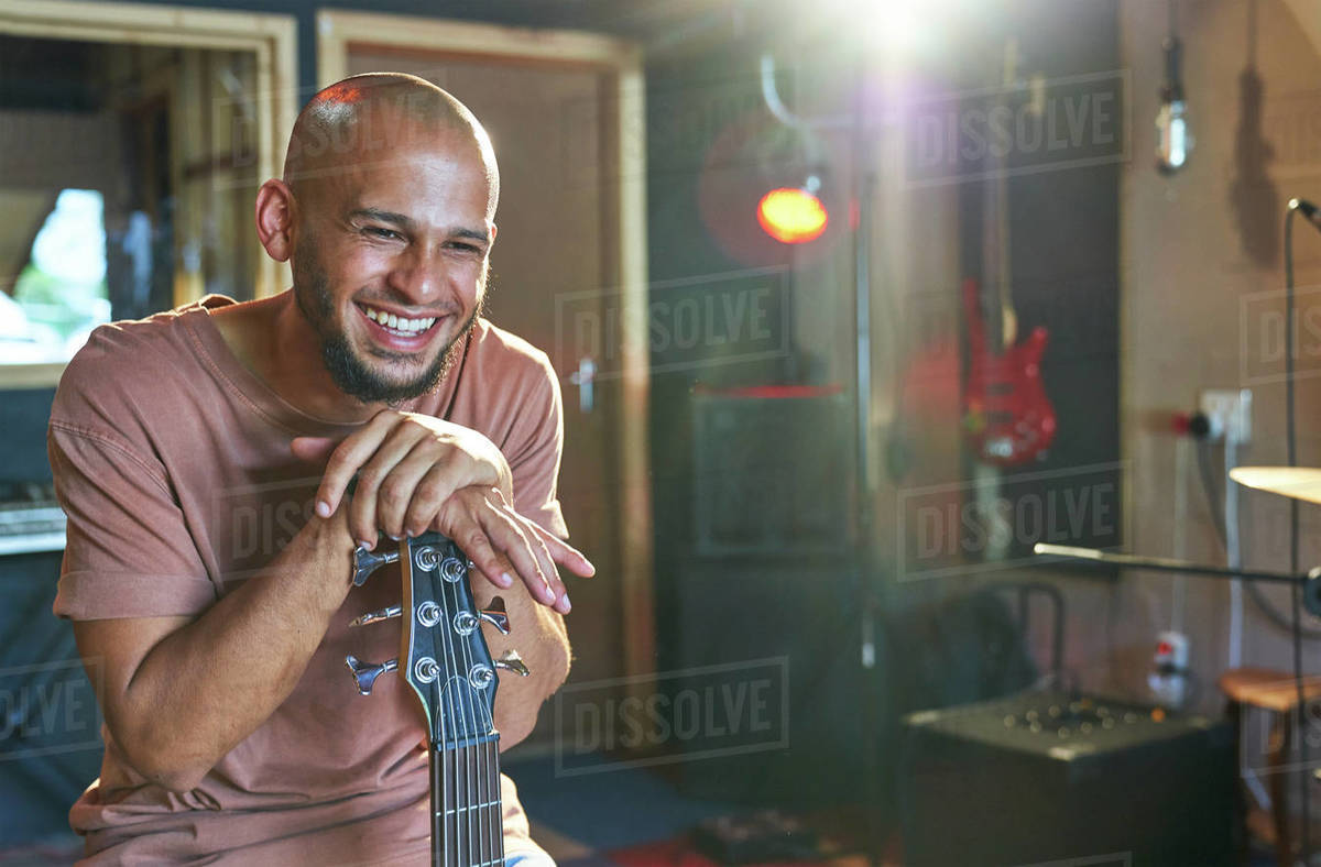 Happy male musician in recording studio - Stock Photo - Dissolve