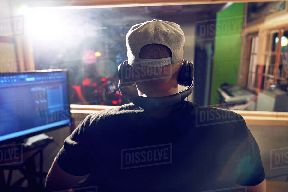 Male music producer working in recording studio sound booth - Royalty ...