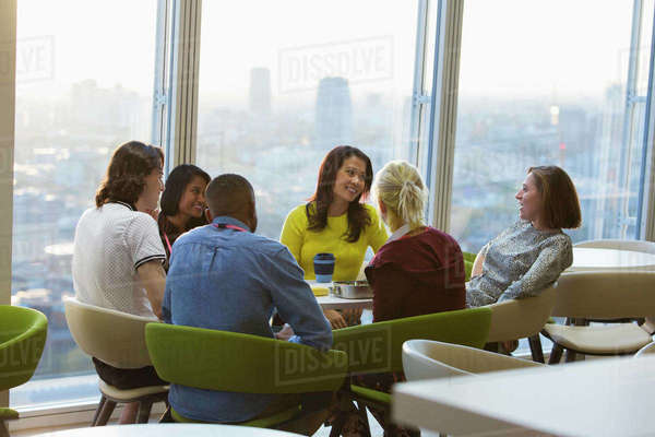 Smiling business people talking over lunch in urban cafeteria - Royalty ...