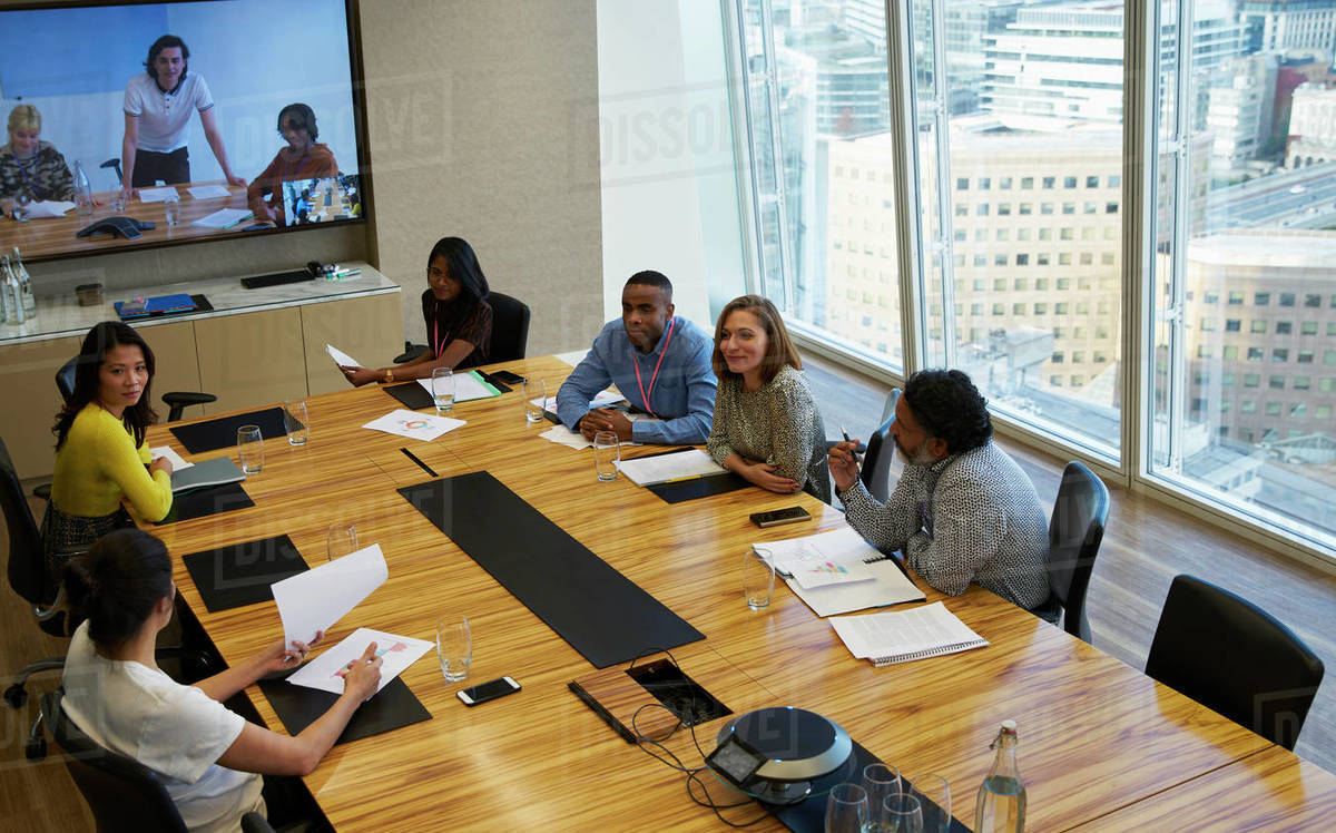 Business people video conferencing in conference room meeting - Royalty ...