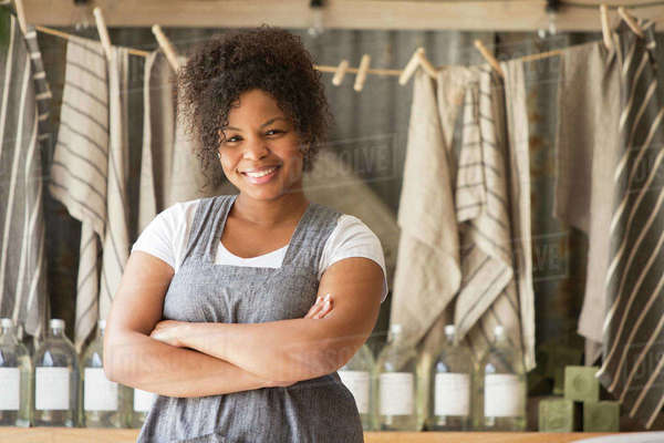 Portrait confident female shop owner with arms crossed - Stock Photo ...