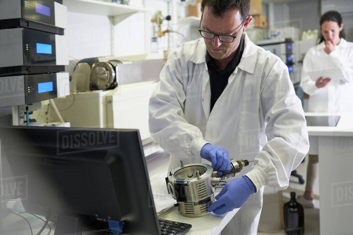 Male scientist using equipment at computer in laboratory - Stock Photo ...