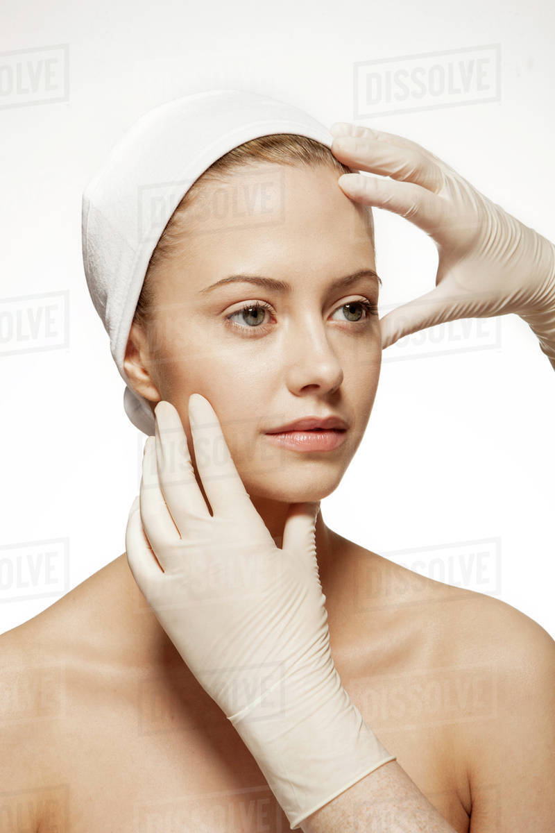 Doctor examining woman's face - Royalty-free Stock Photo | Dissolve