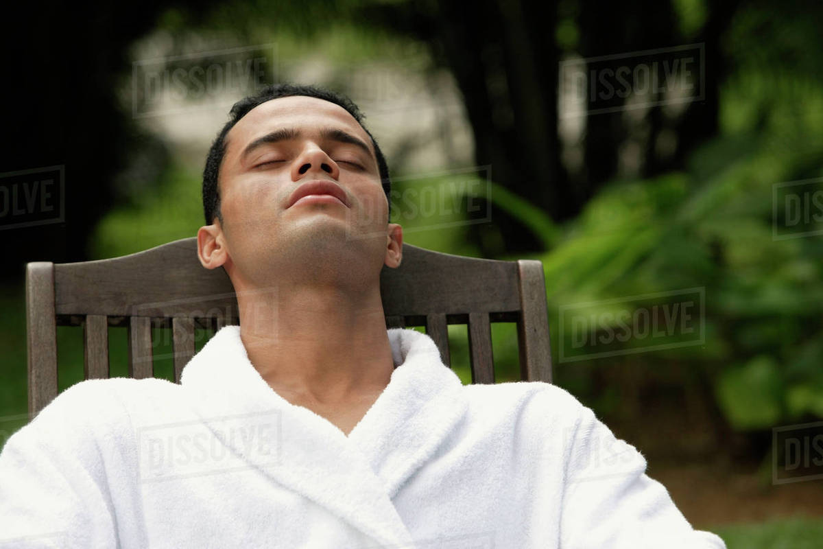 Man sitting outside, wearing robe - Royalty-free Stock Photo | Dissolve