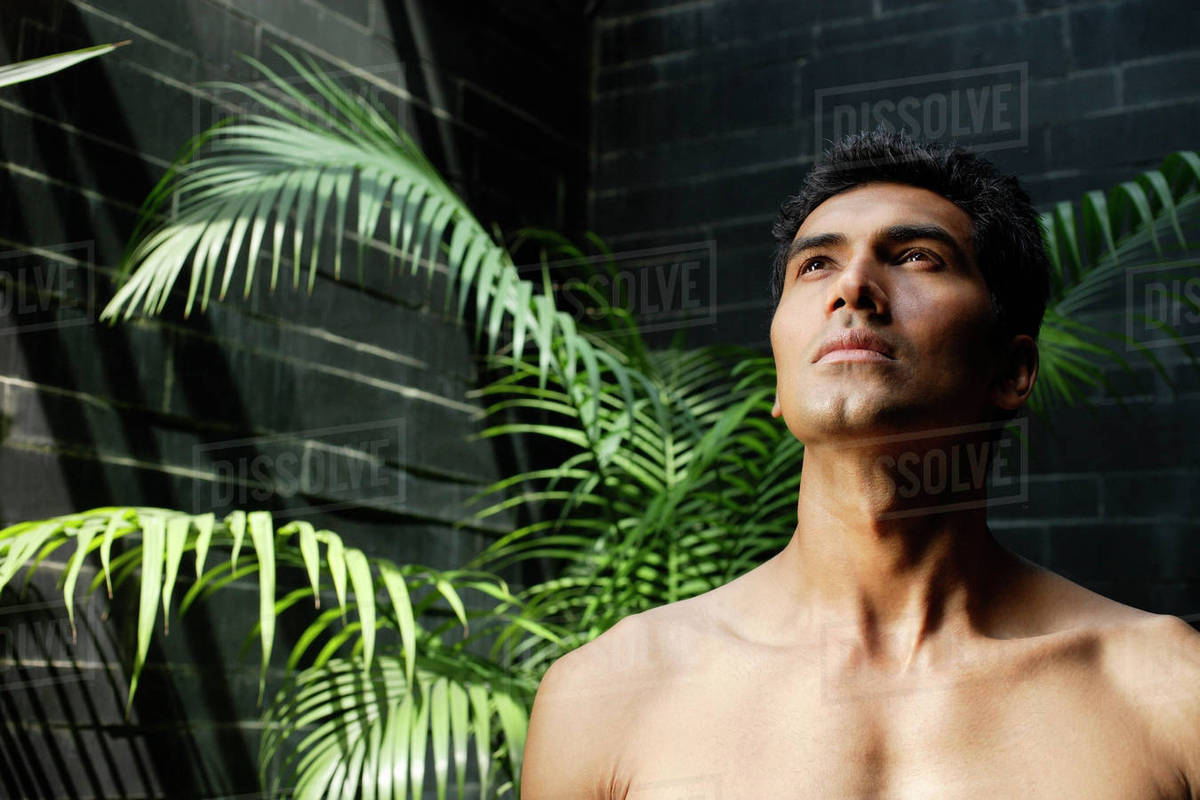 Man surrounded by plants - Royalty-free Stock Photo | Dissolve