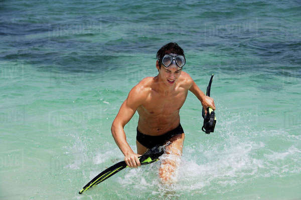 Young man in ocean with mask and fins - Royalty-free Stock Photo | Dissolve