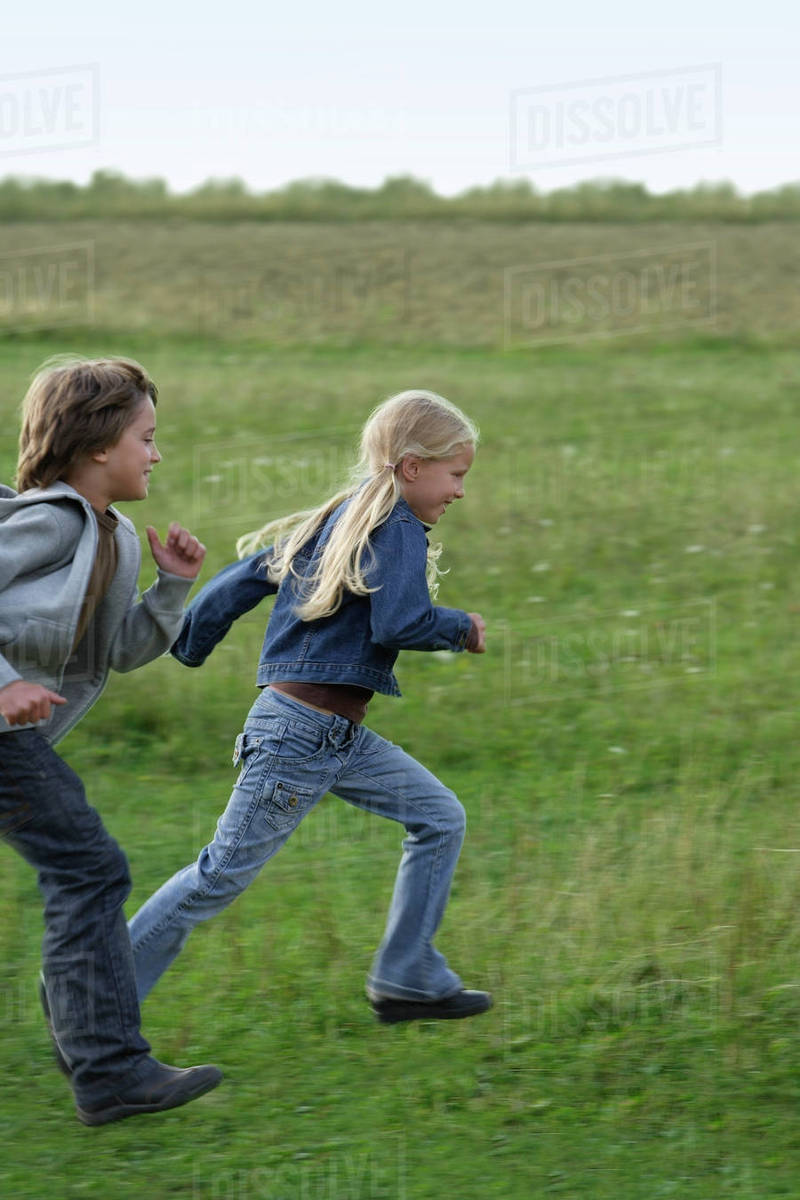 Boy and girl running - Royalty-free Stock Photo | Dissolve