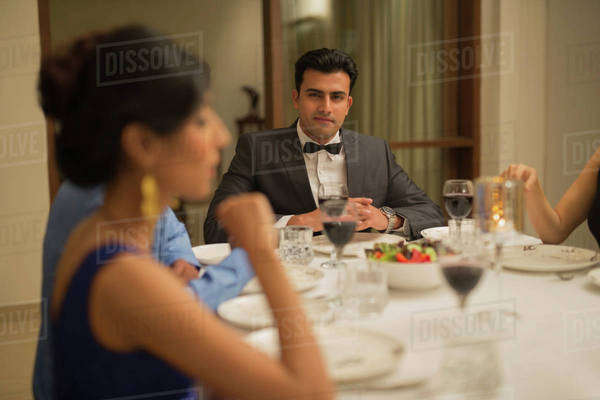 Man looking at woman at formal dining table - Royalty-free Stock Photo ...