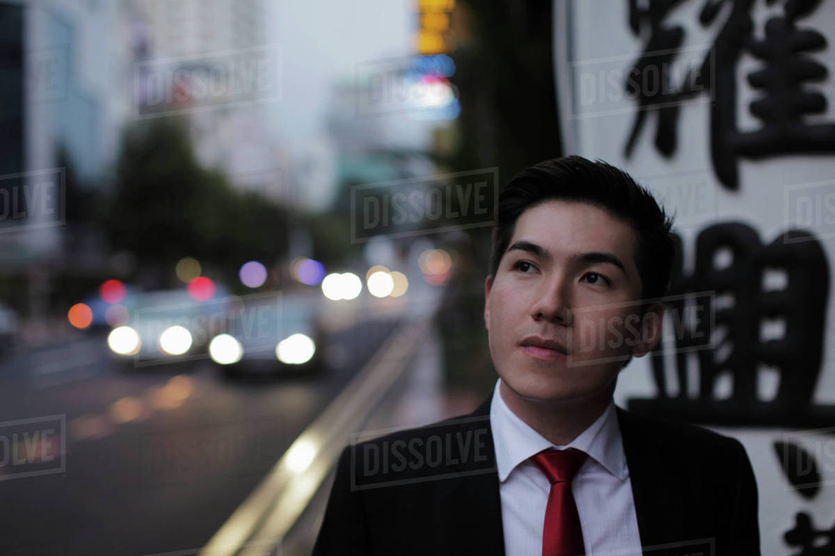 Young man standing by busy road, looking up. - Royalty-free Stock Photo ...