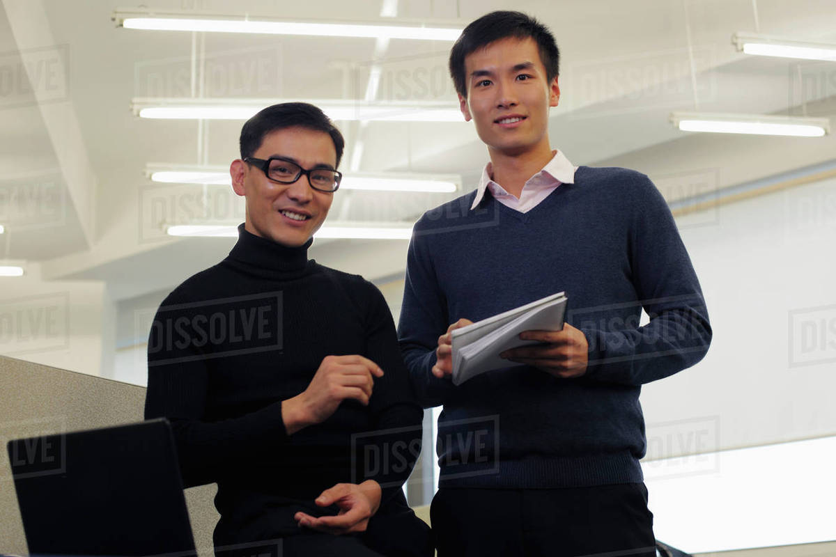 Two men working together in an office - Royalty-free Stock Photo | Dissolve
