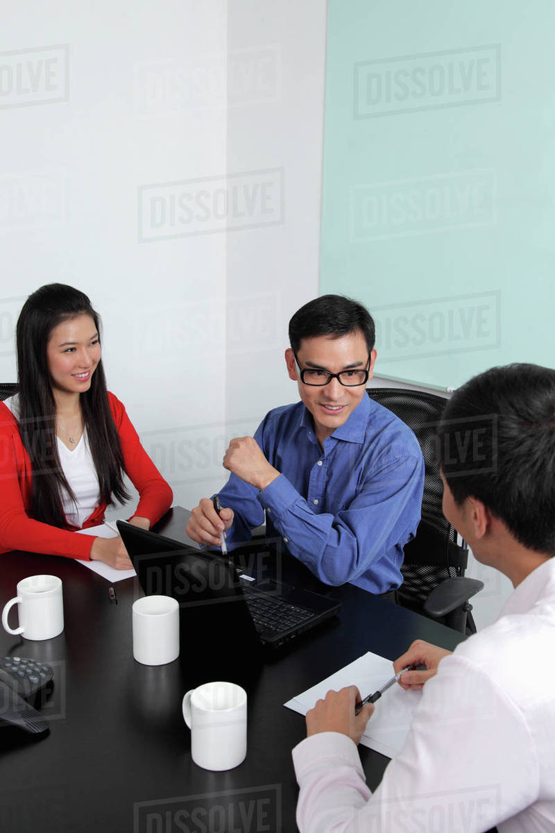 Three people having a meeting - Royalty-free Stock Photo | Dissolve