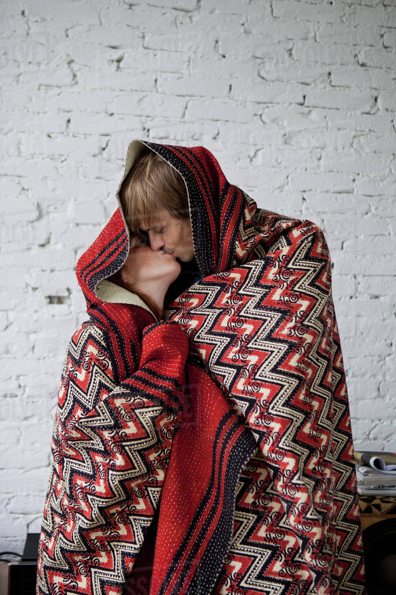 A couple kissing while wrapped in a blanket - Royalty-free Stock Photo ...