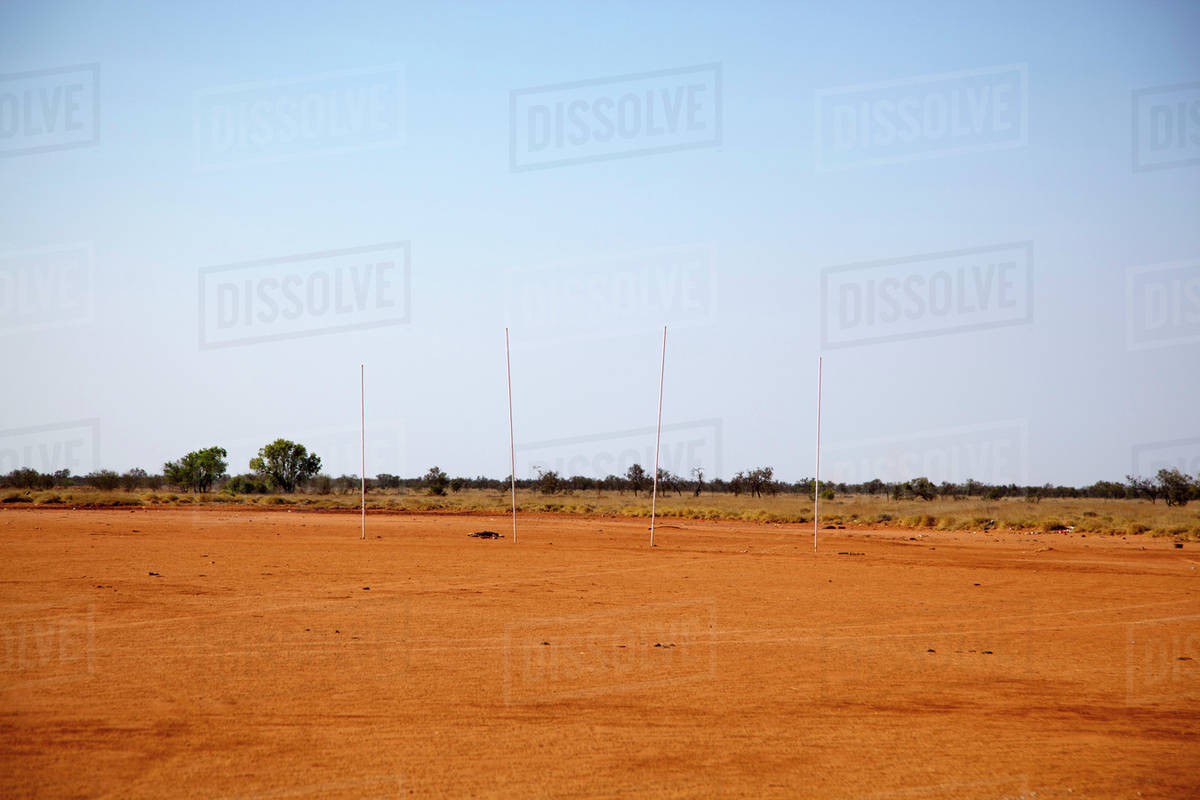 Four sticks stuck in ground, The Pilbara desert, Western Australia ...