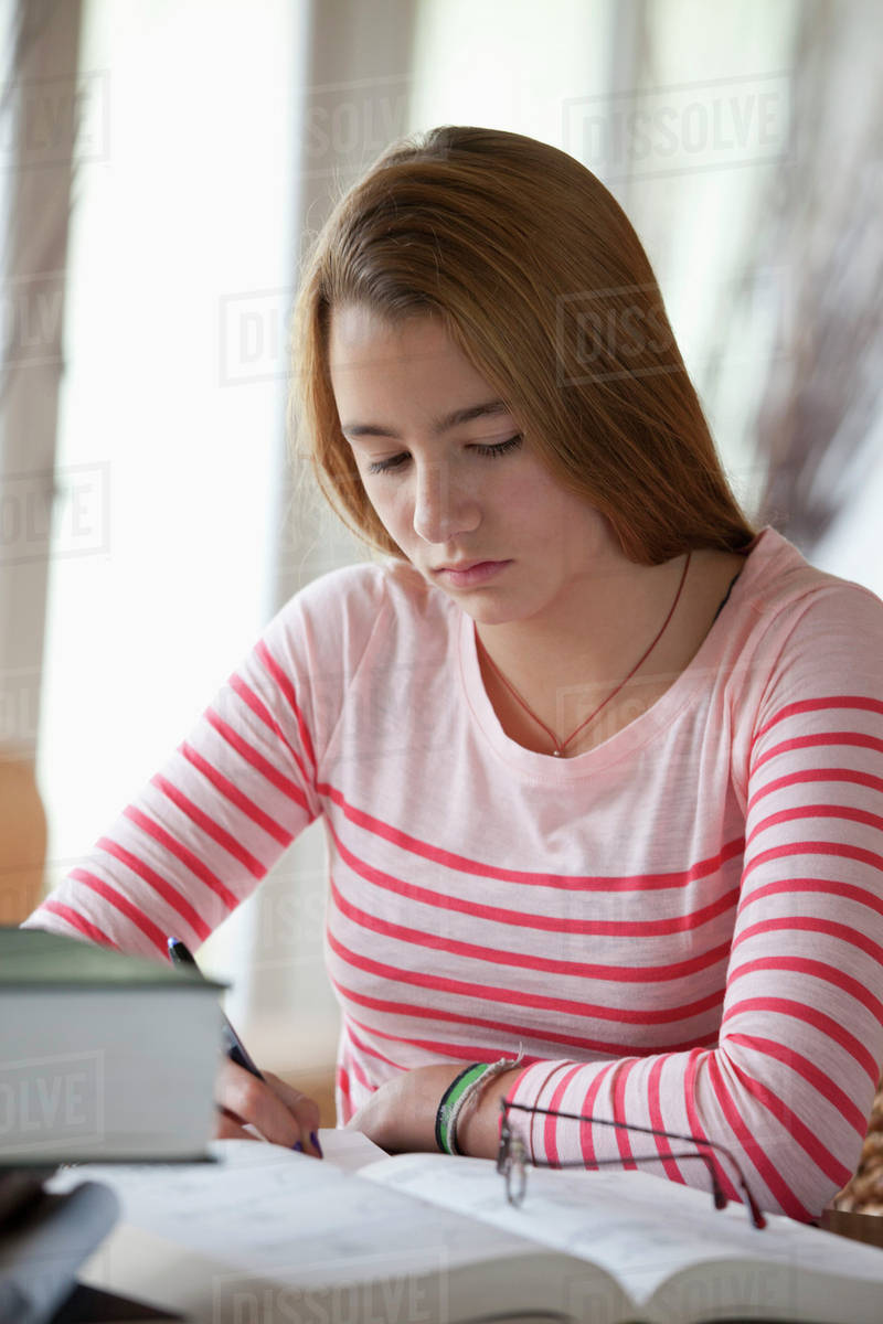 Busy girl doing homework - Royalty-free Stock Photo | Dissolve