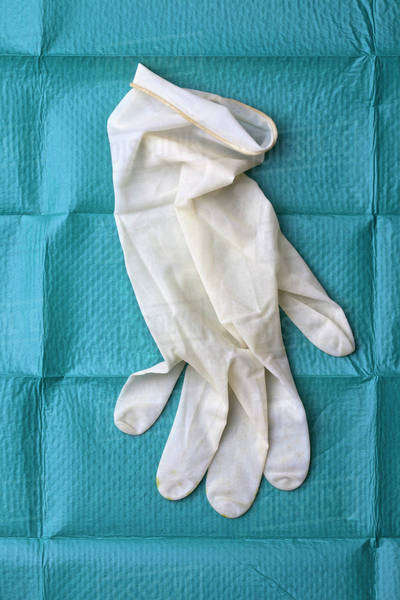 A surgical glove on a surgical drape - Stock Photo - Dissolve