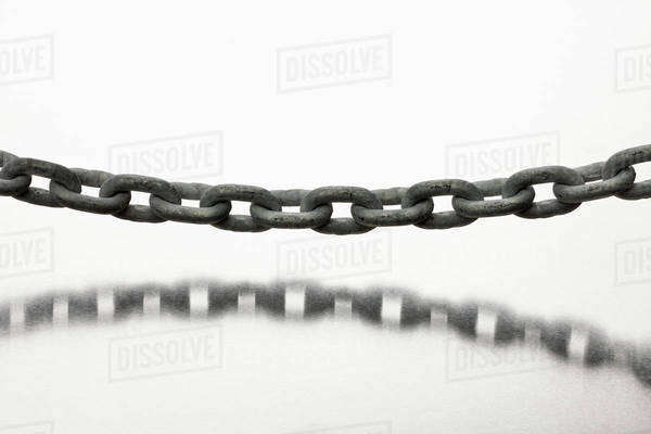A hanging heavy metal chain - Stock Photo - Dissolve