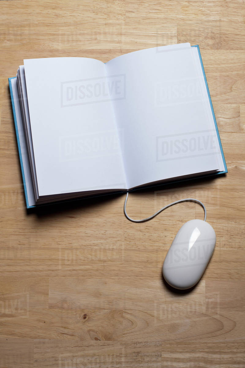 A hardcover book with a computer mouse attached to it - Royalty-free ...
