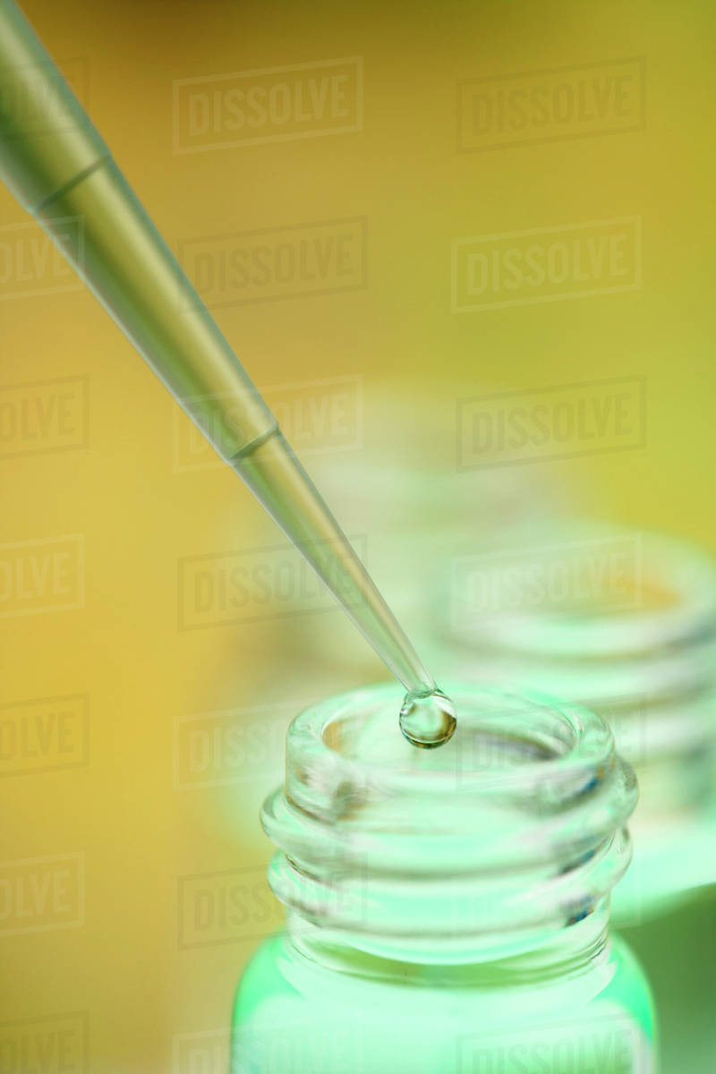 Pipette droplet over lab jar - Stock Photo - Dissolve