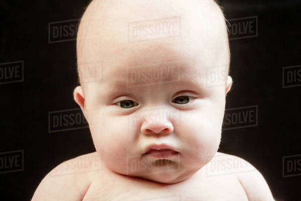Baby pulling a funny face - Royalty-free Stock Photo | Dissolve