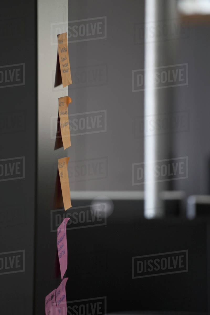 Adhesive notes on wall, close-up - Stock Photo - Dissolve