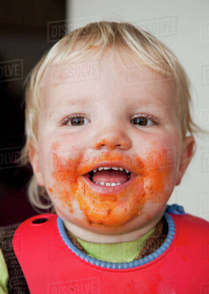 A smiling baby boy with food on his face close-up - Royalty-free Stock ...