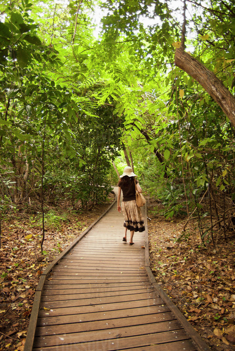A woman walking on path - Royalty-free Stock Photo | Dissolve