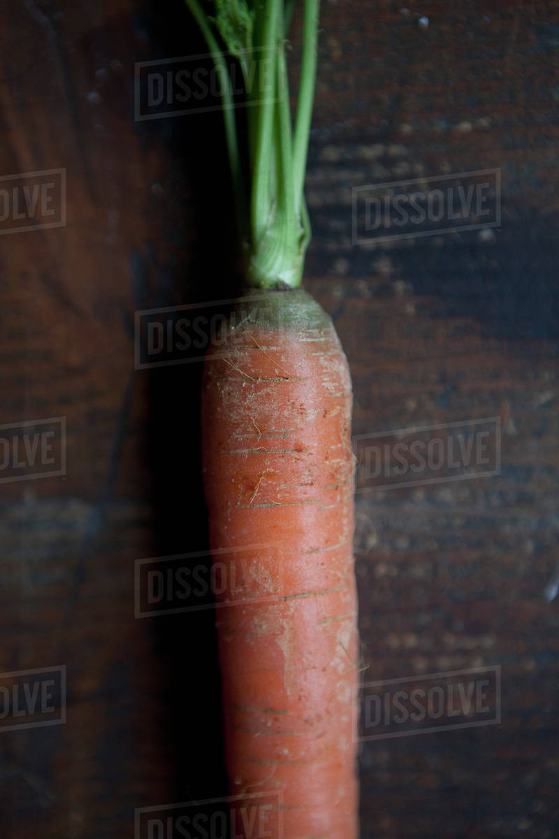 Cropped image of carrot on table - Royalty-free Stock Photo | Dissolve