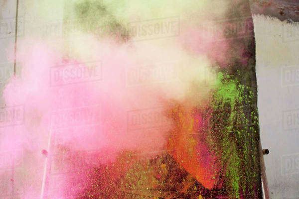 Powder paint spraying during Holi festival - Stock Photo - Dissolve
