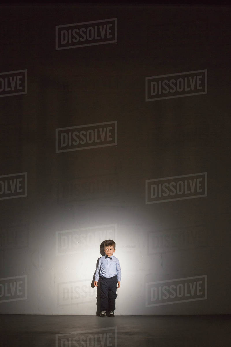 Full length of boy standing against wall - Stock Photo - Dissolve
