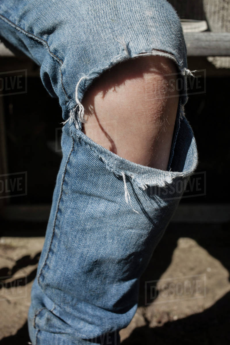 Close-up of person wearing torn jeans - Royalty-free Stock Photo | Dissolve
