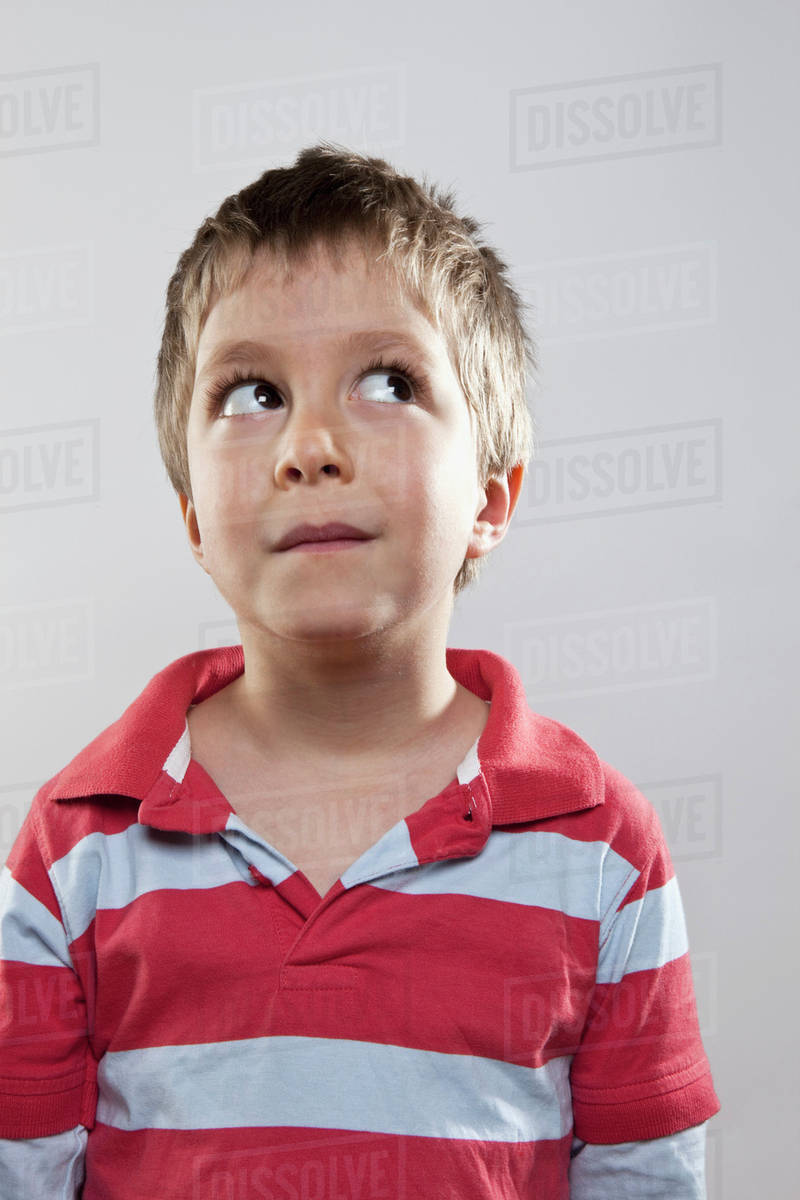 A young boy looking up and to the side, studio shot - Royalty-free ...