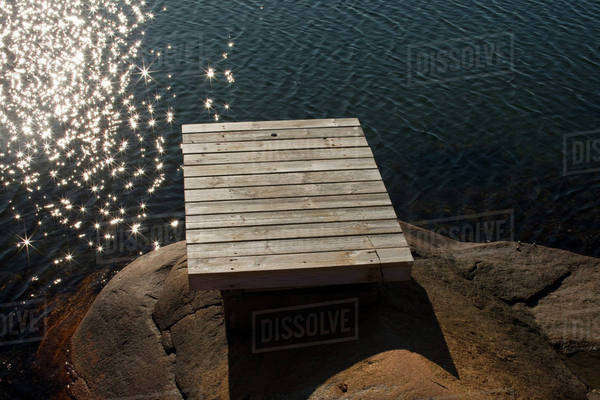 A wooden platform at the edge of water - Royalty-free Stock Photo ...
