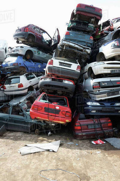Cars stacked in scrap yard - Royalty-free Stock Photo | Dissolve