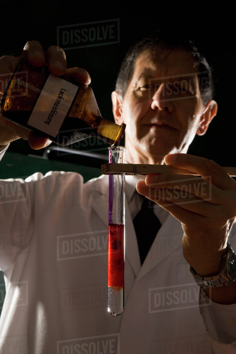 A scientist pouring liquid into a test tube - Royalty-free Stock Photo ...