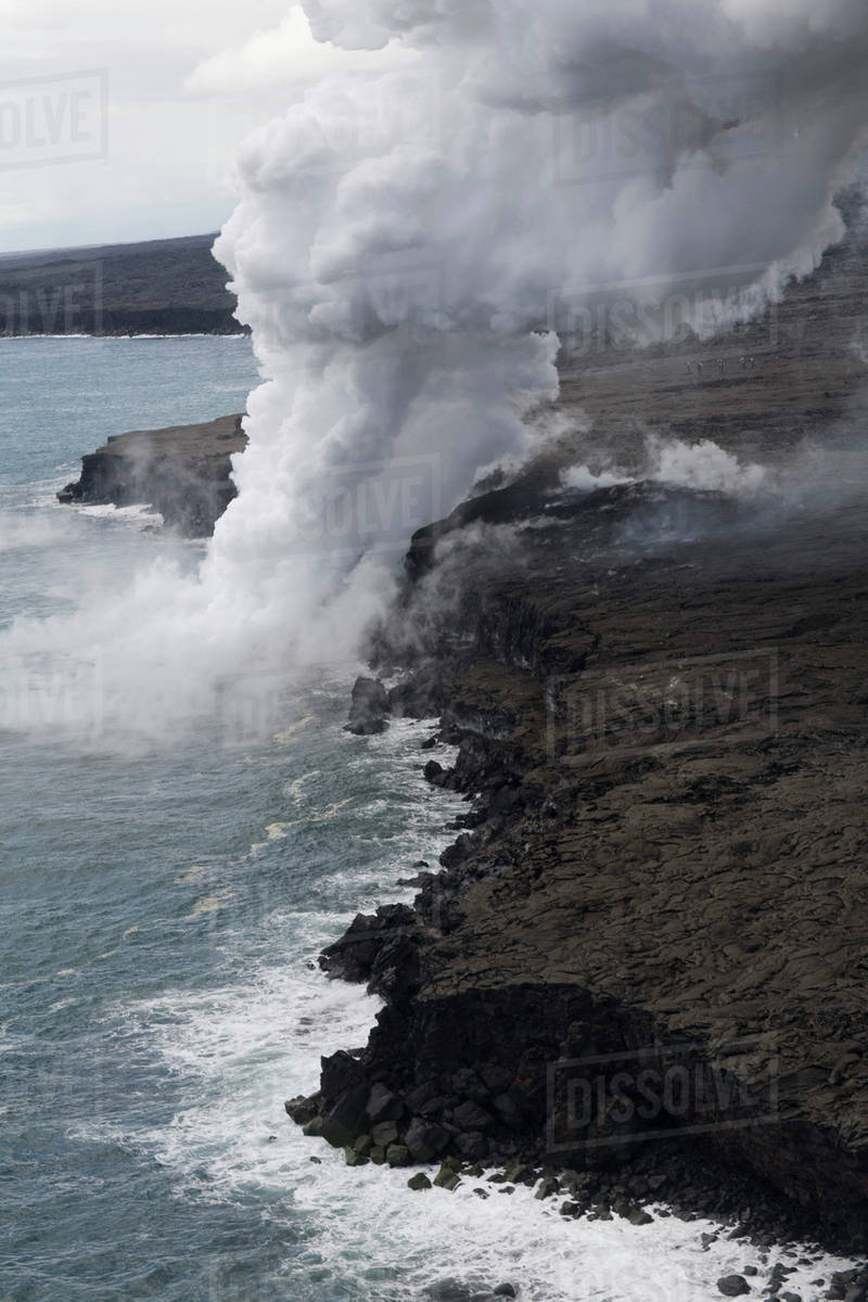 Steam from volcano flowing into Hawaiian sea - Royalty-free Stock Photo ...