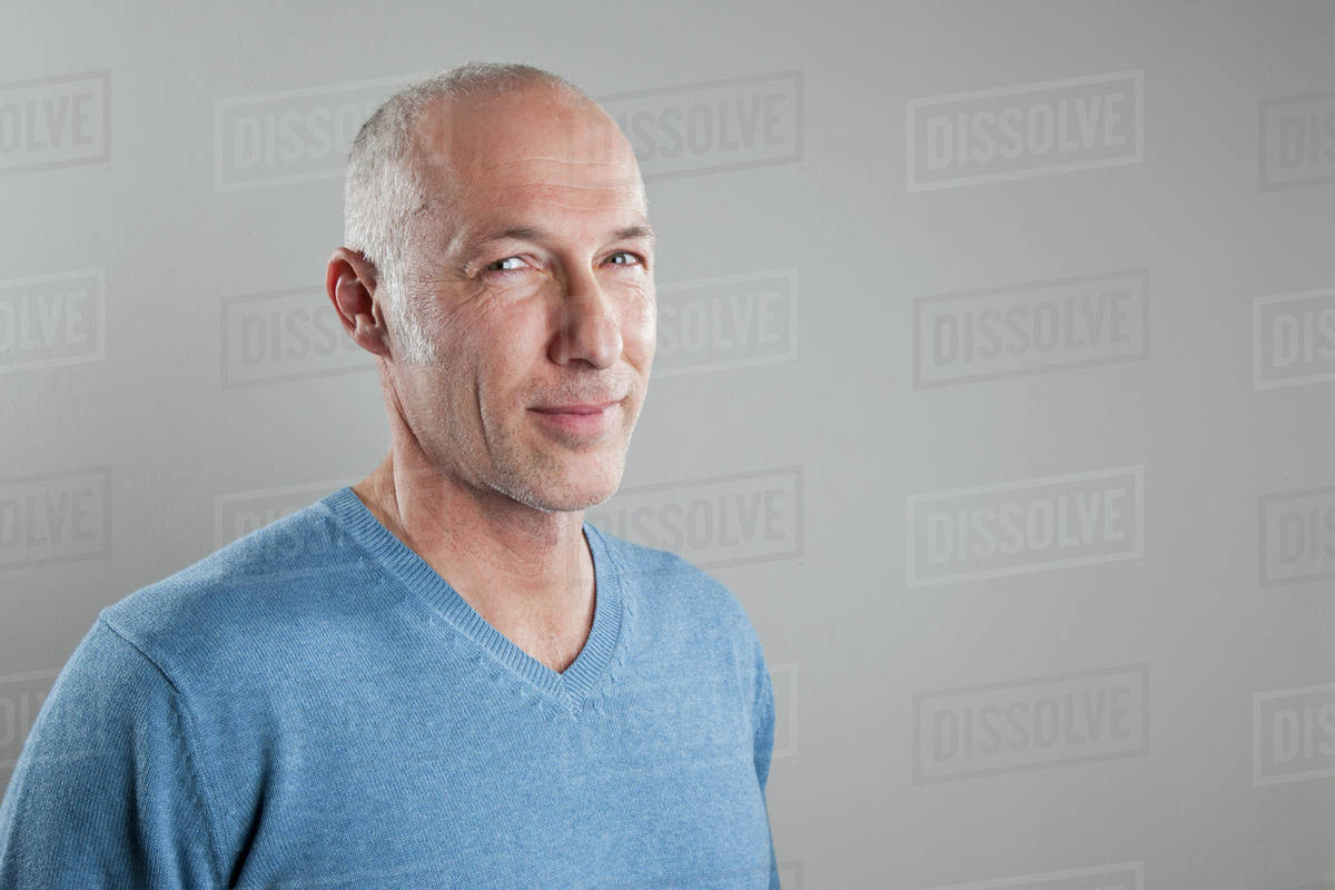 A mature man looking suspicious, portrait - Stock Photo - Dissolve
