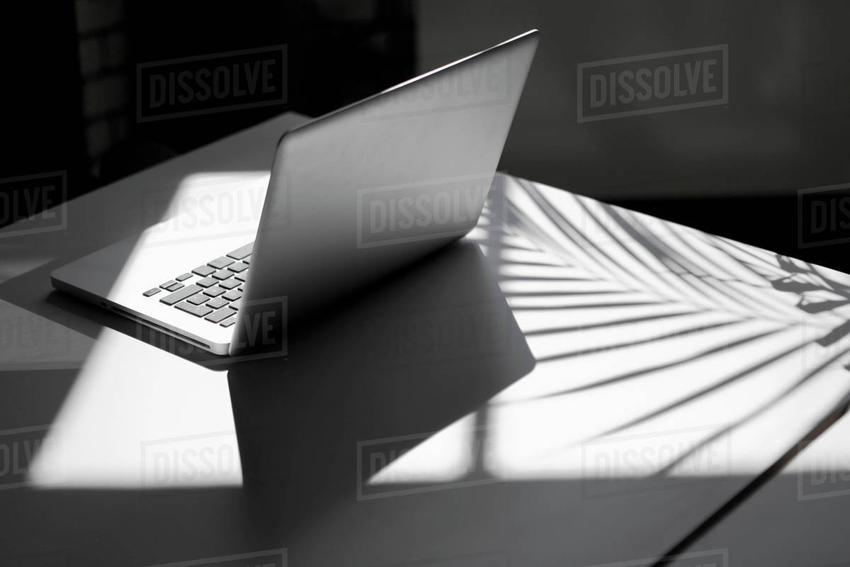 Laptop on table, close-up - Royalty-free Stock Photo | Dissolve