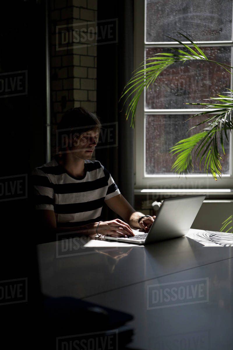 Man using laptop - Royalty-free Stock Photo | Dissolve