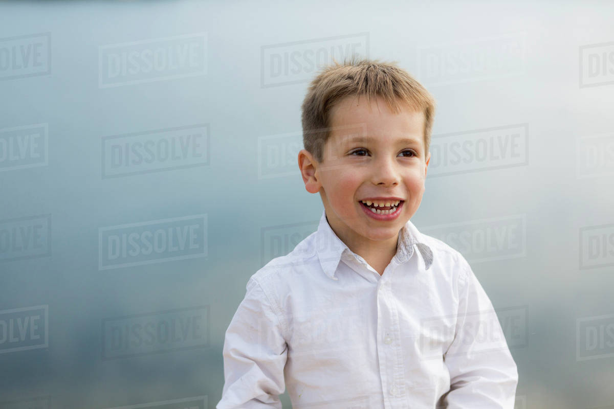 Happy boy looking away outdoors - Royalty-free Stock Photo | Dissolve