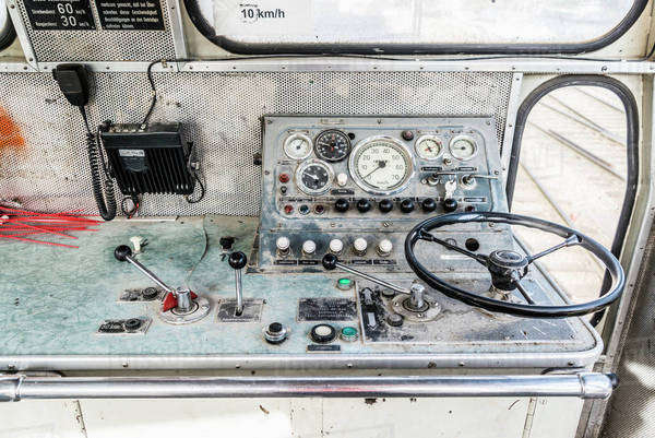 Steering wheel and control panel in train - Stock Photo - Dissolve