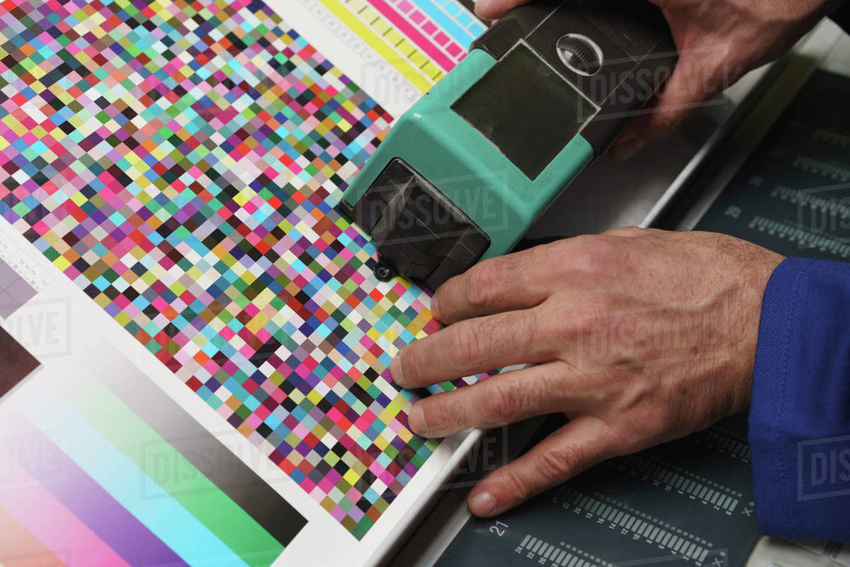 Cropped image of hand holding scanner and checking quality of printed ...